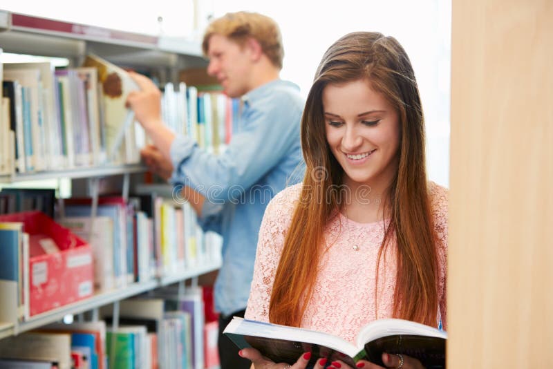 Two College Students Studying in Library Stock Photo - Image of smiling ...