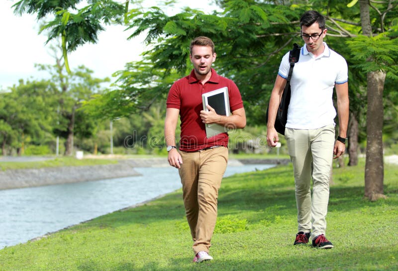 Two College Students Walking Together at Riverside Stock Image - Image ...