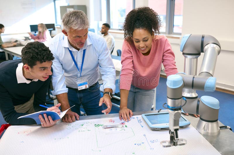 Two College or University Engineering Students and Male Teacher in ...