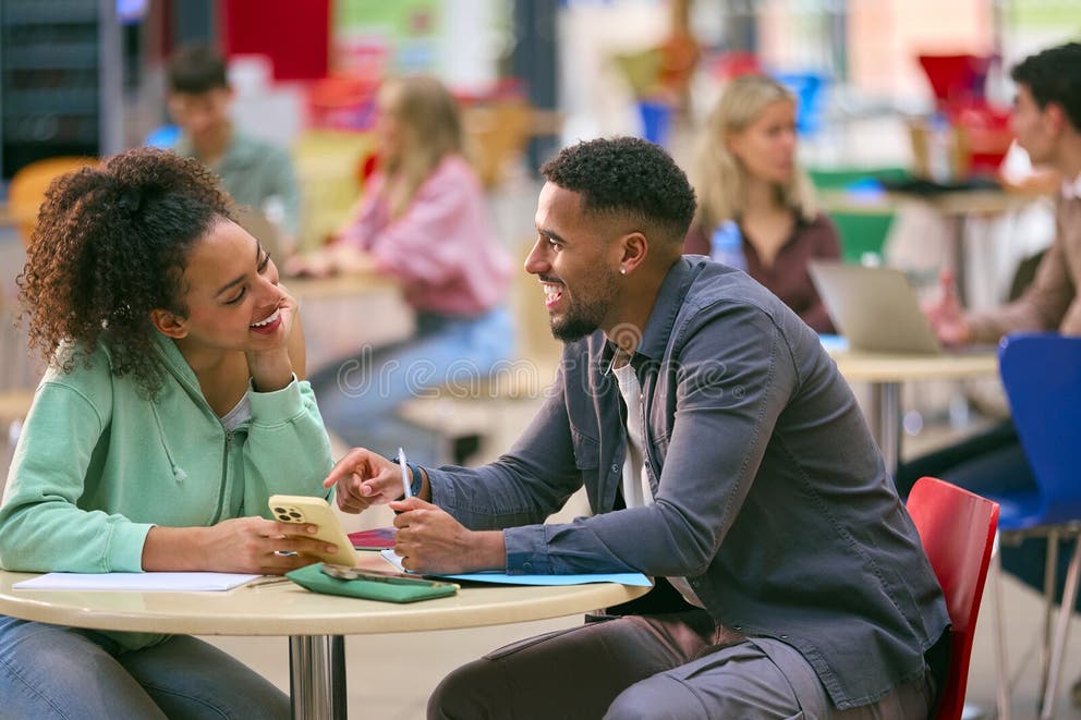 Two College or University Students with Mobile Phone Working Together ...