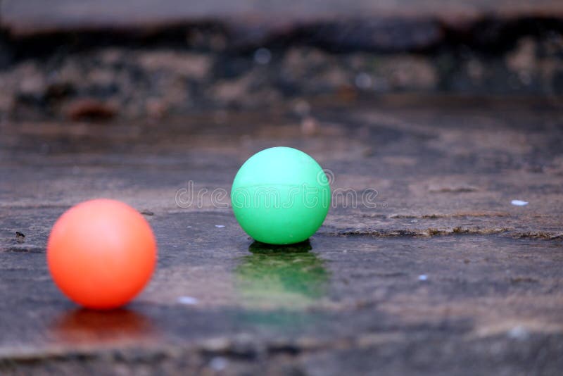 Two Color Ball on Wet Stone Stock Photo - Image of playful, activity ...