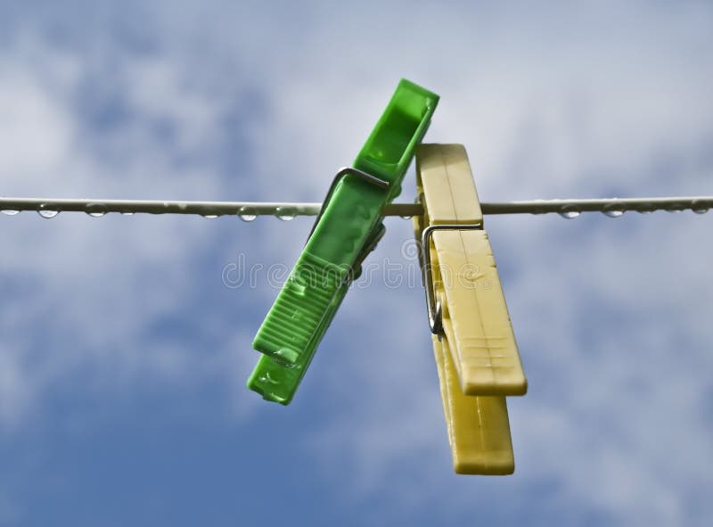 Two Color Pegs in a Cloth Line Stock Image - Image of blue, cable: 15595057