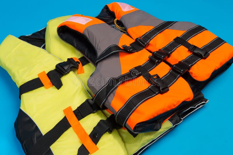 Two Colored Life Jackets on a Blue Background, Concept of Saving Life ...
