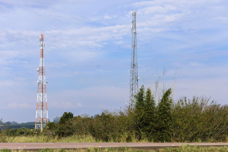 Two Communication Towers with Cloudy Sky in the Background Stock Image ...