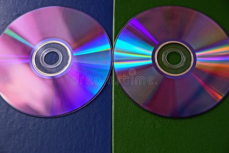 Two Compact Discs on a Blue Green Surface Stock Photo - Image of ...