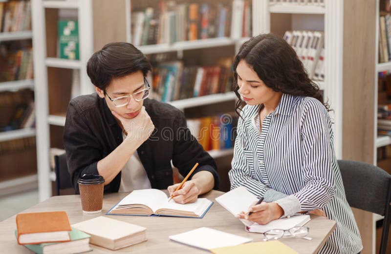 Two Concentrated Multiracial Students Learning at Library Stock Image ...