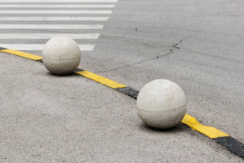 Two concrete balls, Two concrete balls as a border between sidewalk and