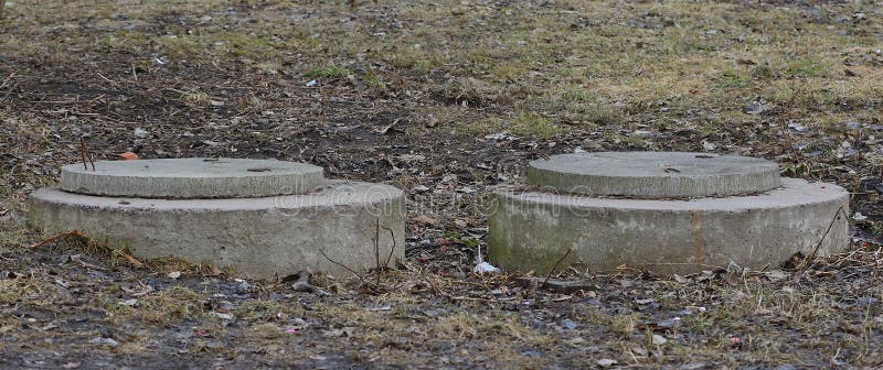 Two Concrete Manholes in the Spring Ground Stock Image - Image of sewer ...