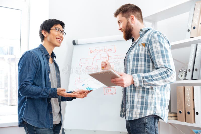 Two Confident Businessmen Making Business Plan Using Tablet and ...
