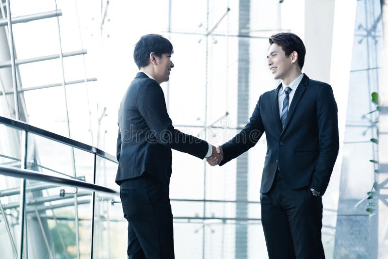 Confident Businessmen Shaking Hands and Smiling Stock Image - Image of ...