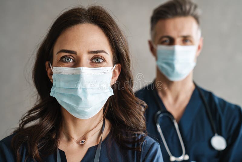 Two Confident Doctors in Medical Masks Standing Stock Photo - Image of ...