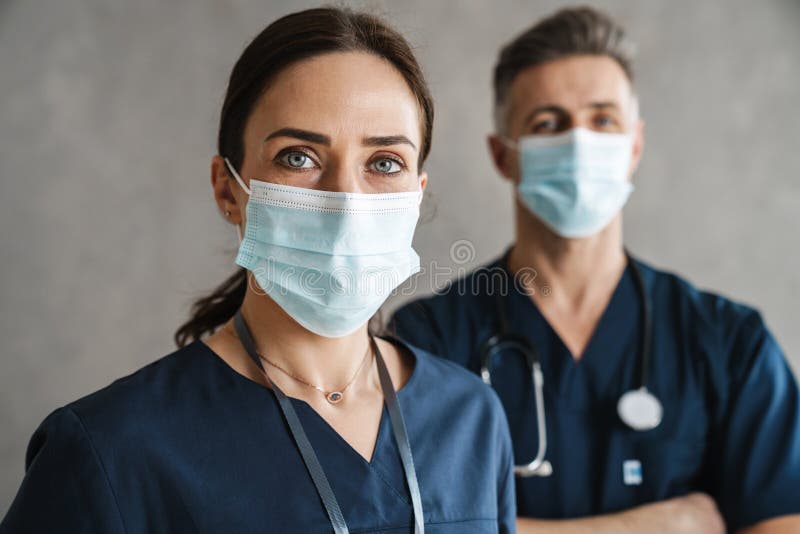 Two Confident Doctors in Medical Masks Standing Stock Photo - Image of ...