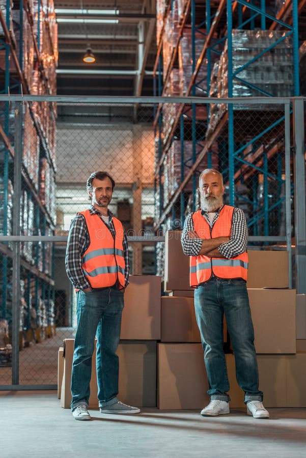 Two Confident Male Warehouse Workers Looking Stock Photo - Image of ...