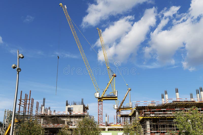 Two Construction Cranes on a Building Construction. High Crane on a ...