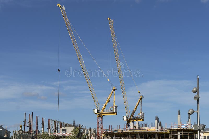 Two Construction Cranes for Building a House. the Construction of a ...