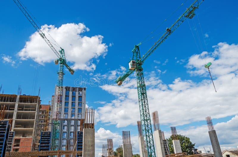 Two construction cranes stock image. Image of investment - 192789343