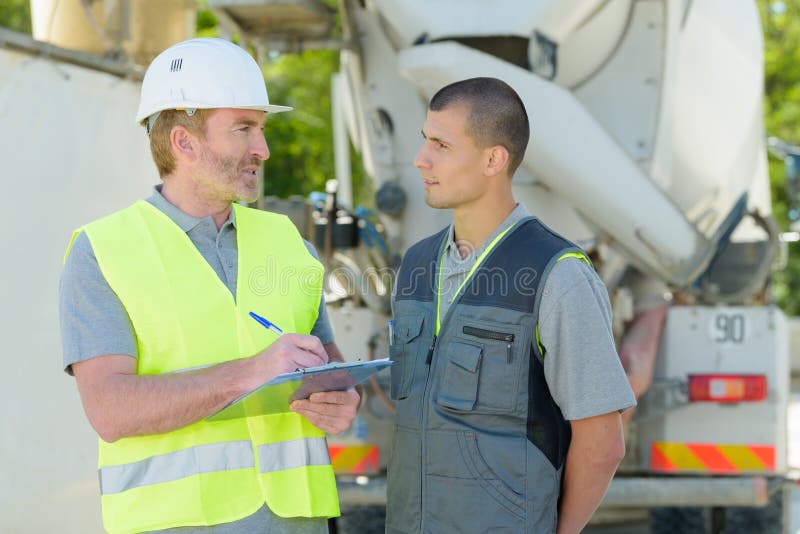 Two Construction Engineers Supervising Work at Building Site Stock ...