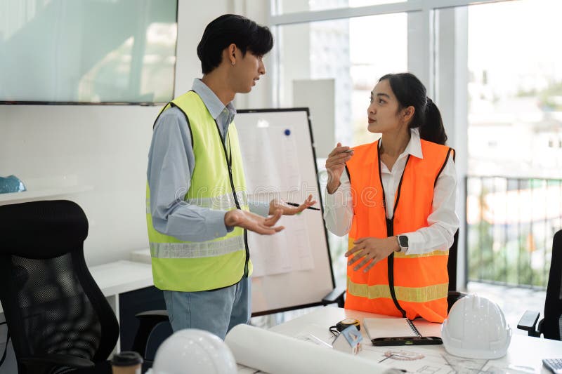 Construction Professionals Discussing Project Details and Strategies in ...