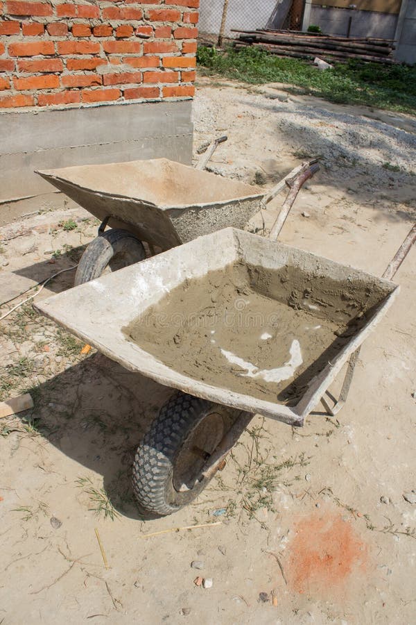 Man with a Wheelbarrow at a Construction Site,hard Work of a Builder ...