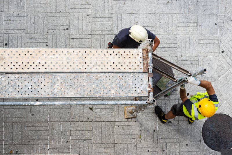 Two Construction Workers Assembling European Scaffolding Stock Image ...