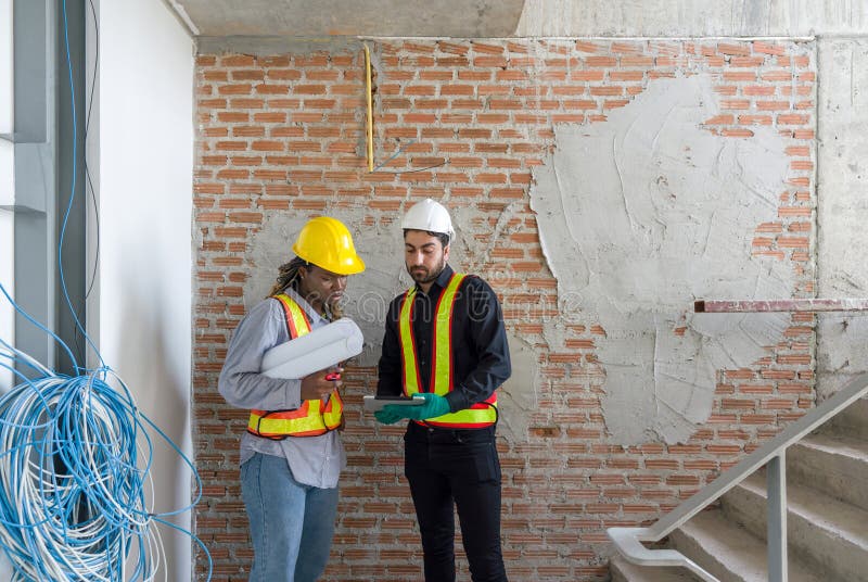 Two Construction Workers Checking Work Schedule on Tablet Computer ...