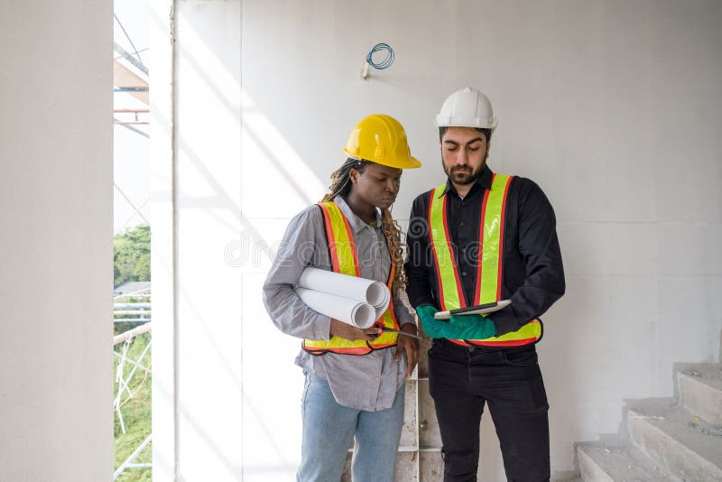Two Construction Workers Checking Work Schedule on Tablet Computer ...