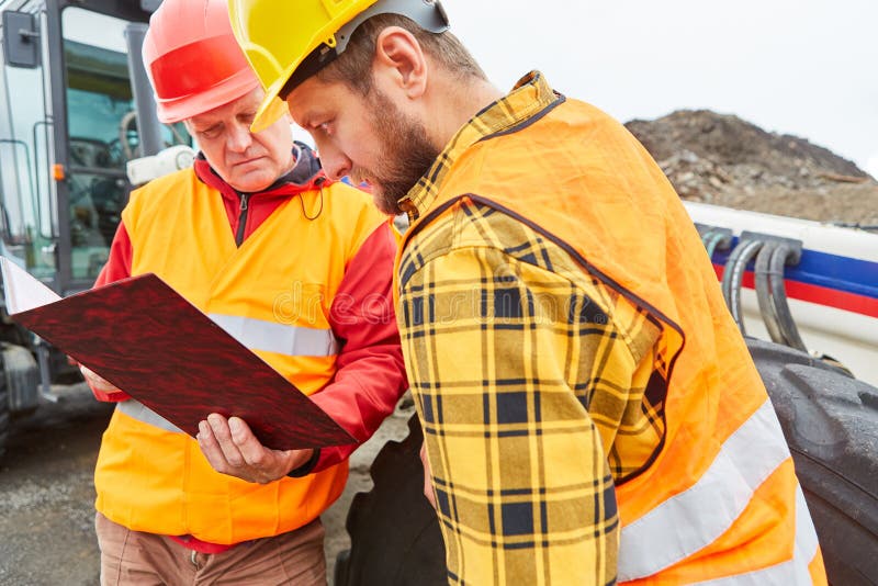 Two Construction Workers Check a Building Permit Stock Photo - Image of ...
