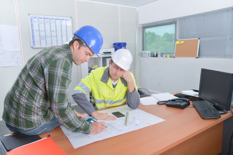 Two Construction Workers Discussing Plans Stock Photo - Image of ...