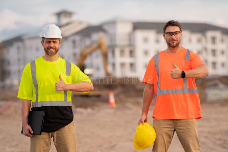 Two Construction Workers with Hardhat Helmet on Construction Site ...