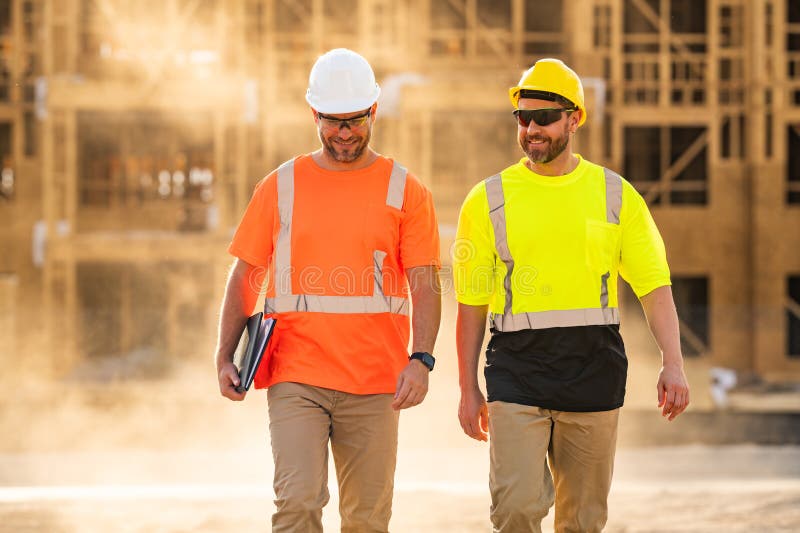Two Construction Workers with Hardhat Helmet on Construction Site ...