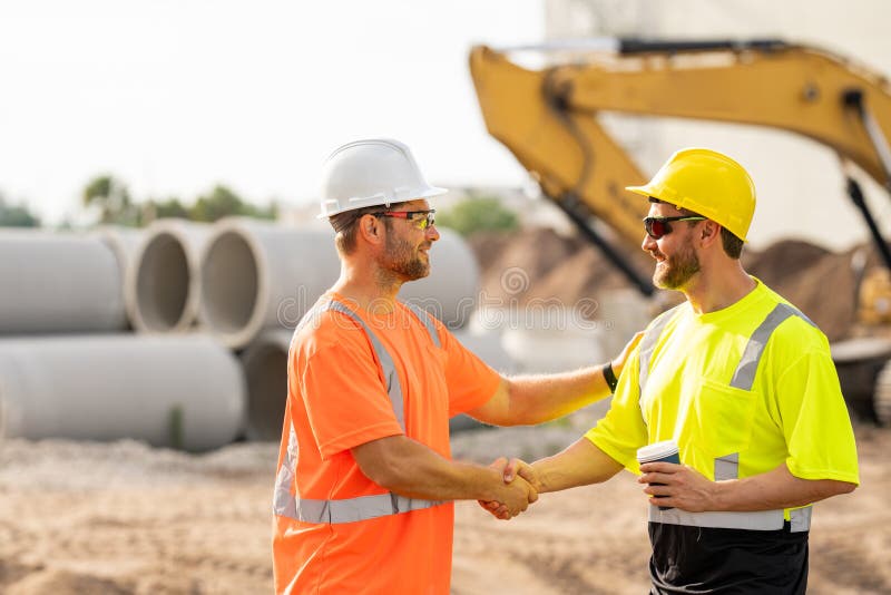 Two Construction Workers with Hardhat Helmet on Construction Site ...