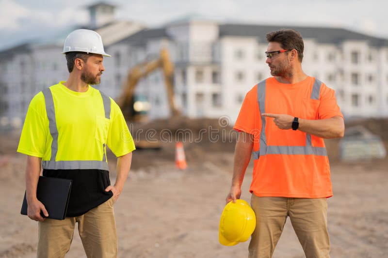 Two Construction Workers with Hardhat Helmet on Construction Site ...