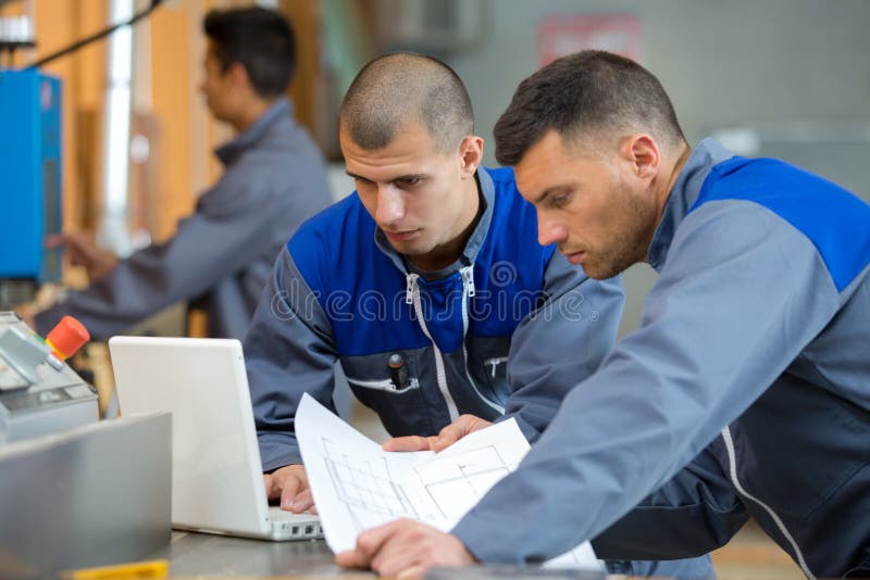Two Construction Workers Holding Plans Discussing Project Stock Image ...
