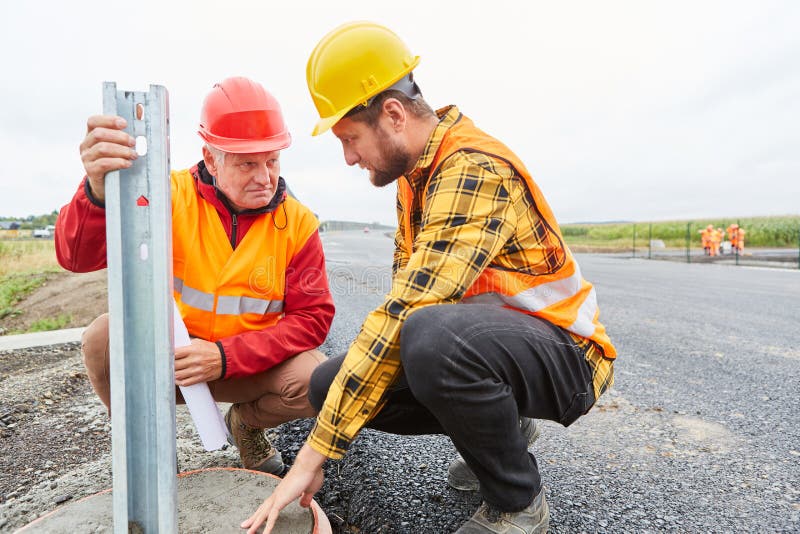 Two Construction Workers during an Inspection on the Construction Site ...