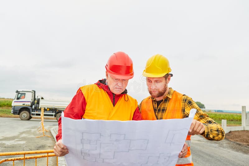 Two Construction Workers Look at a Floor Plan Stock Image - Image of ...