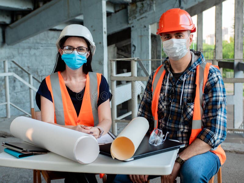 An Architect and Foreman in Medical Masks at a Meeting To Agree on the ...