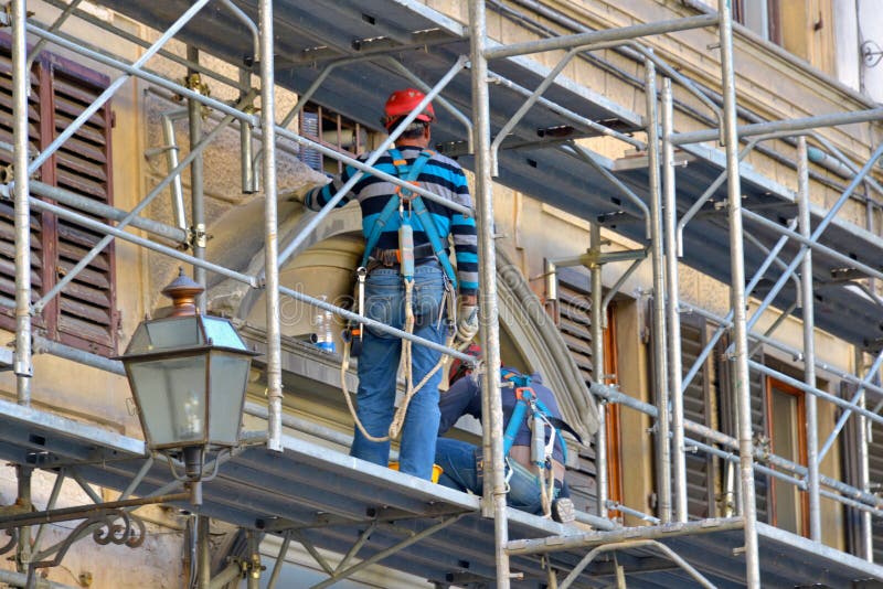 Two Construction Workers are Reconstructing the Facade Editorial ...