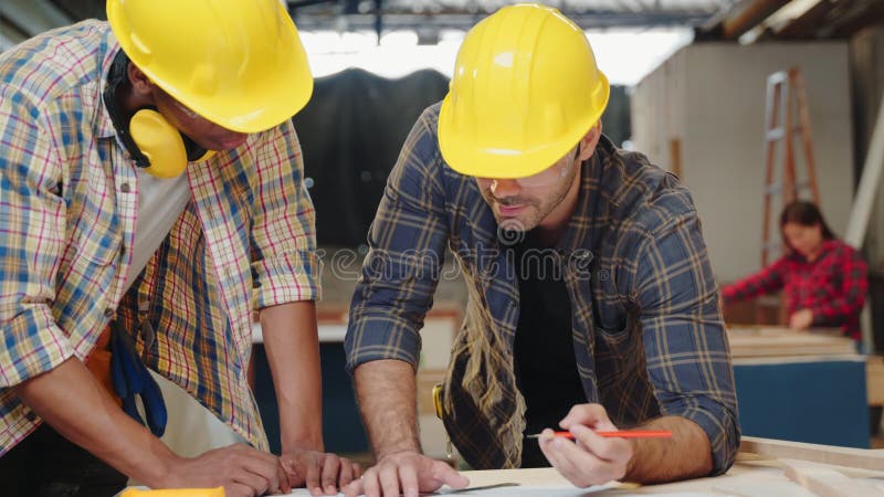Two Construction Workers Reviewing Blueprints, Wearing Helmets, and Planning Stock Video - Video ...