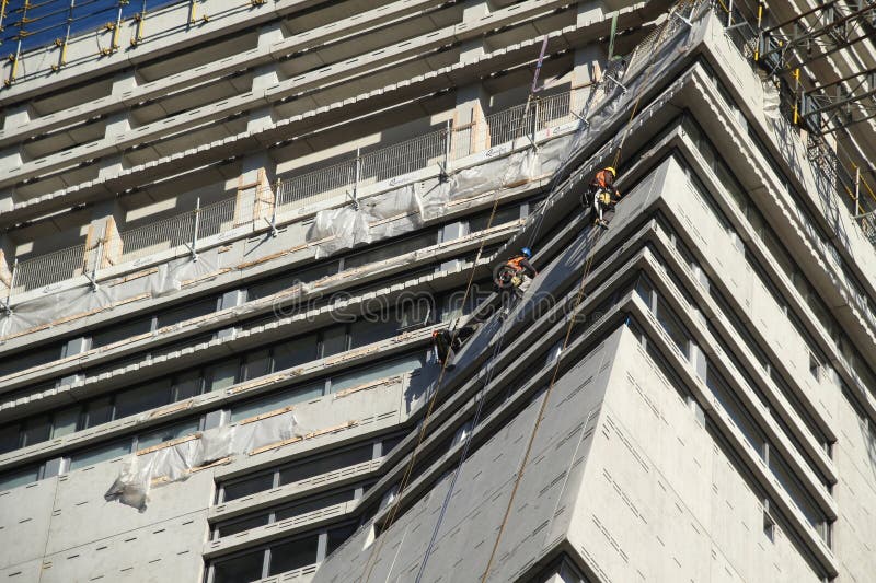 Construction Workers on Scaffolding at Site of Tall Building Stock ...