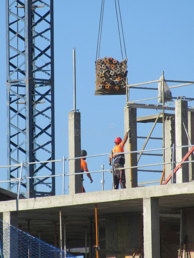 Two Construction Workers Working on a Construction Site. Bricklayer ...