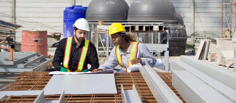 Two Construction Workers are Working on Construction Tasks in Front of ...