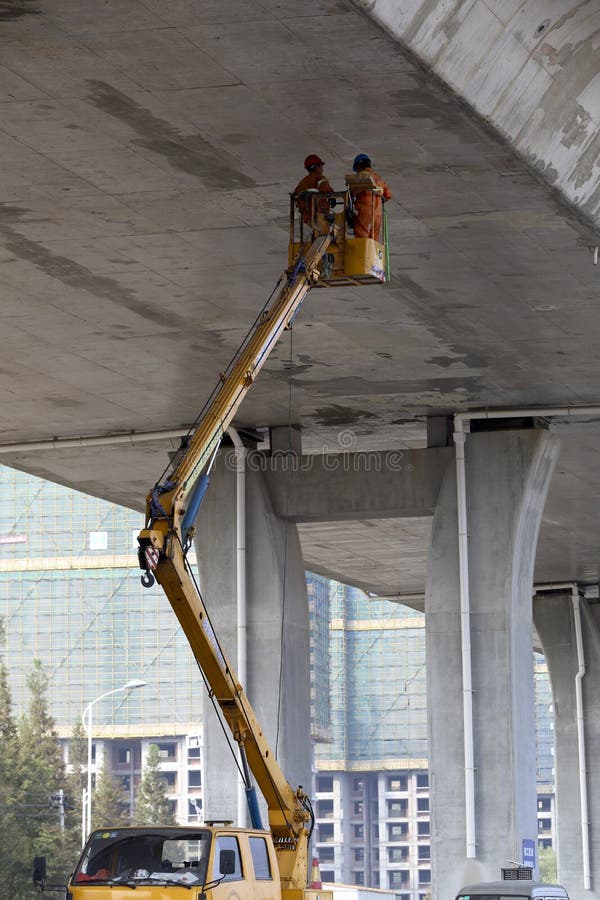 Two Construction Workers are Working Under a Road Editorial Stock Image ...