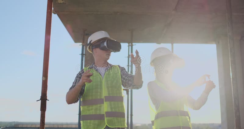 Two Contemporary Crew Workers Using VR To Visualize Projects Standing ...