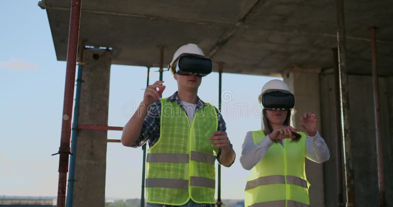 Two Contemporary Crew Workers Using VR To Visualize Projects Standing ...