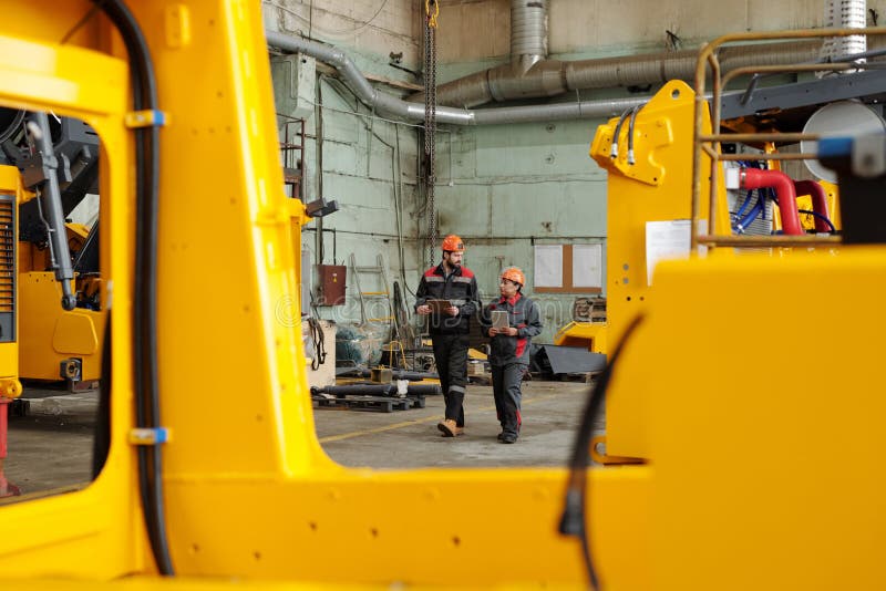 Two Contemporary Workers of Large Industrial Plant Moving Along ...