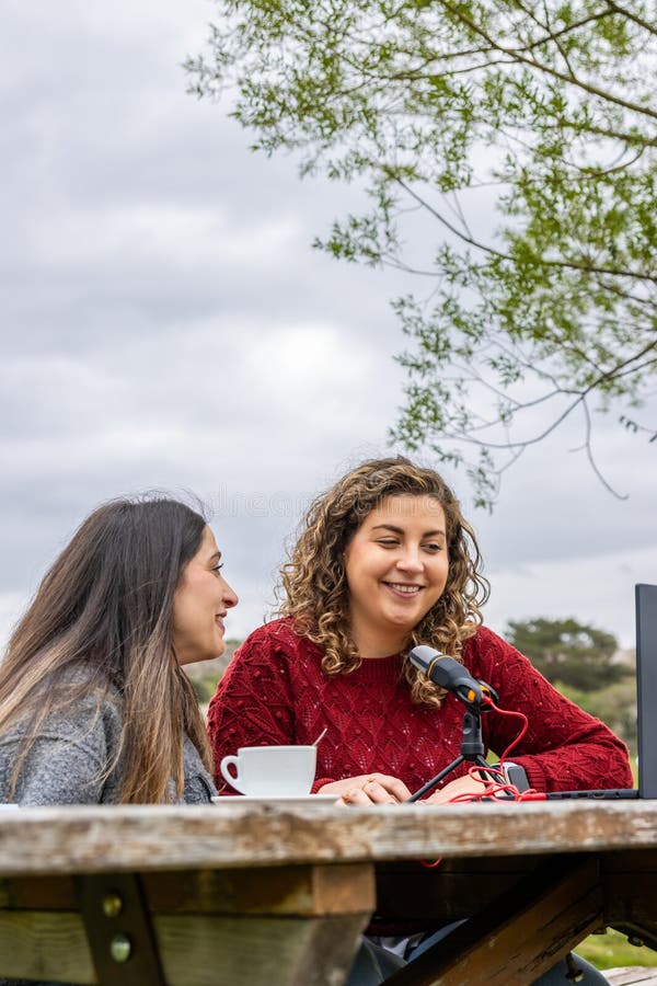 Two Content Creators Recording Podcast Outdoors with Laptop and ...
