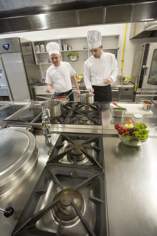 Two Cook Chefs in Professional Kitchen Stock Photo - Image of food ...