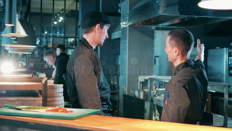 Two Cooks are Talking in the Restaurant Kitchen Stock Footage - Video ...