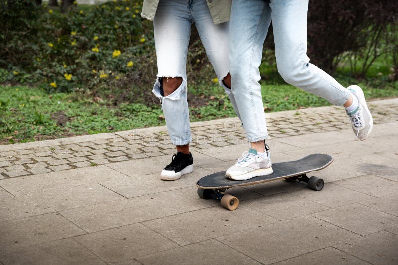 Two Cool-looking Hipster Friends in Park Learning To Ride a Skateboard ...