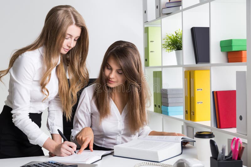 Two Cooperating Young Ladies Stock Image - Image of design, consulting ...